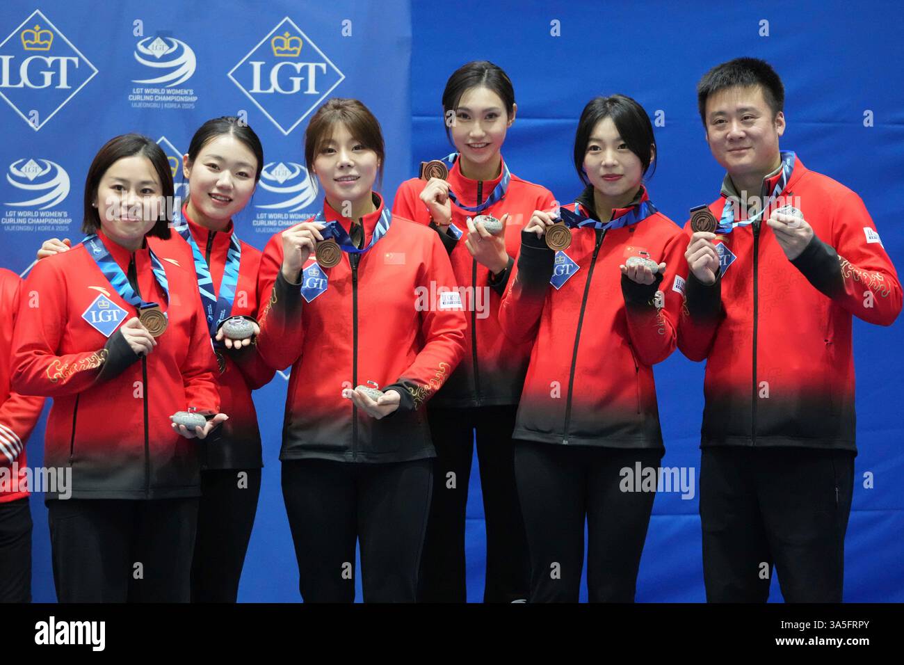 China's skip Wang Rui, Han Yu, Dong Ziqi, Jiang Jiayi, Su Tingyu and coach Zang Jialiang pose ...