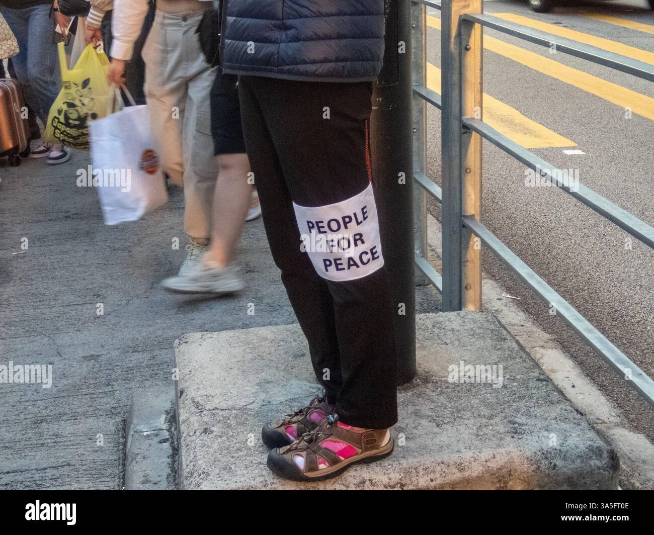 Hong Kong, China. 22nd Mar, 2025. A “People for Peace” sign is attached ...