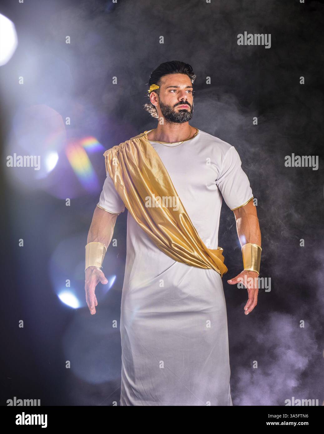 Serious bearded man in Greek god or Roman aristocrat costume holding ...