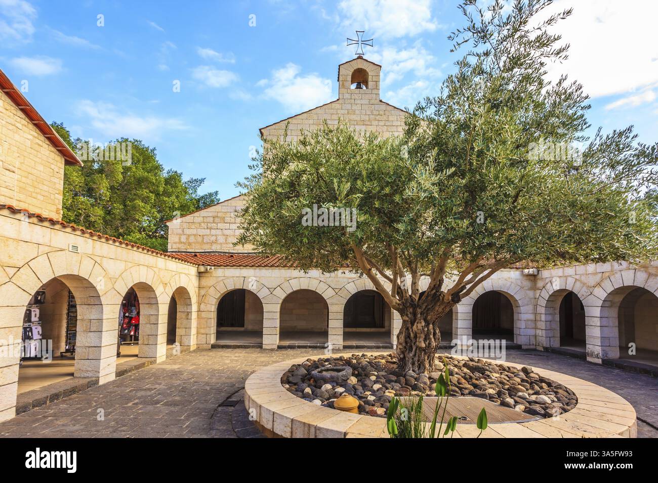 Small cozy church yard on the Sea of Galilee, Israel. Round bed with ...
