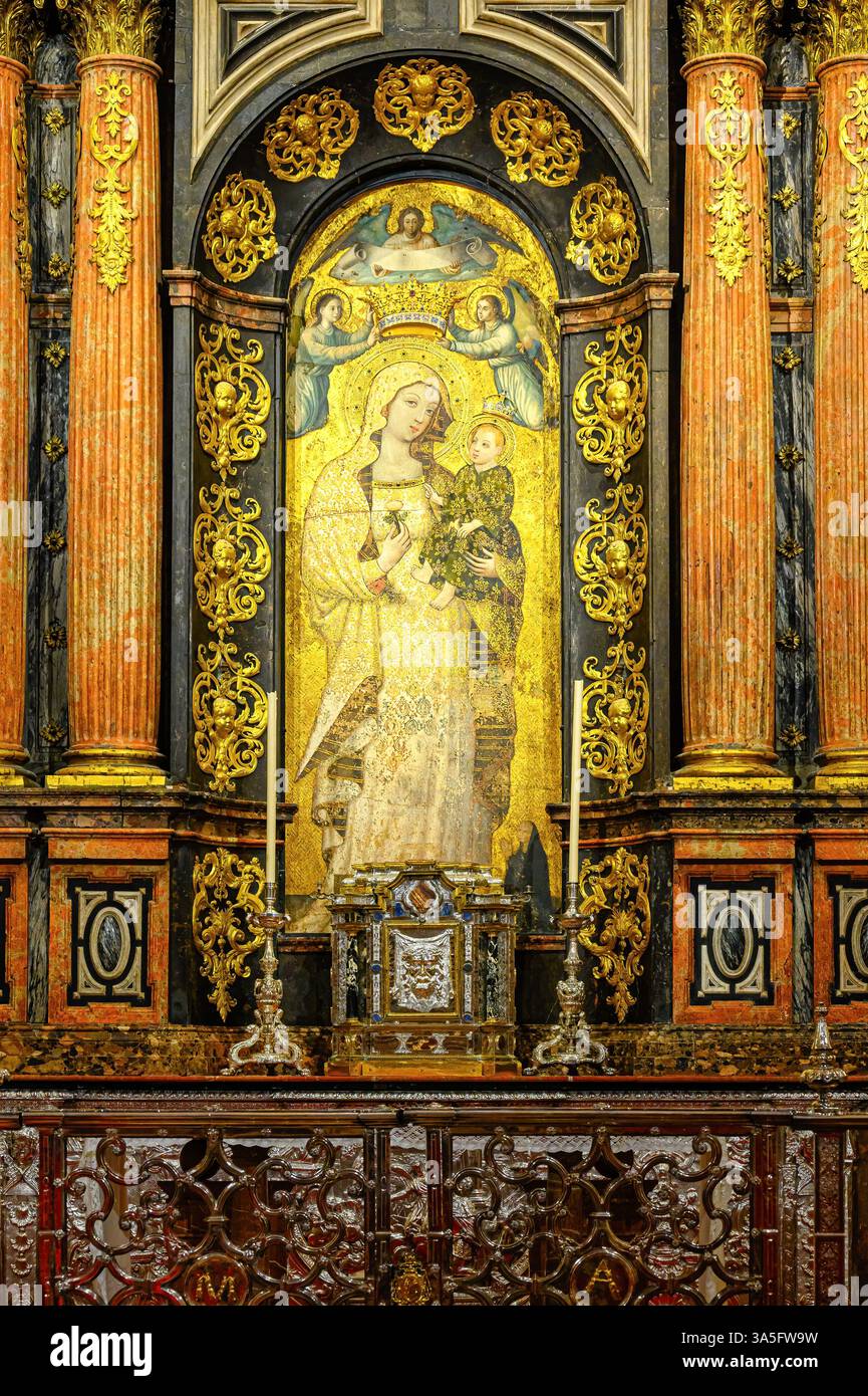 Ancient artwork of the Virgin Mary and baby Jesus between stone columns ...