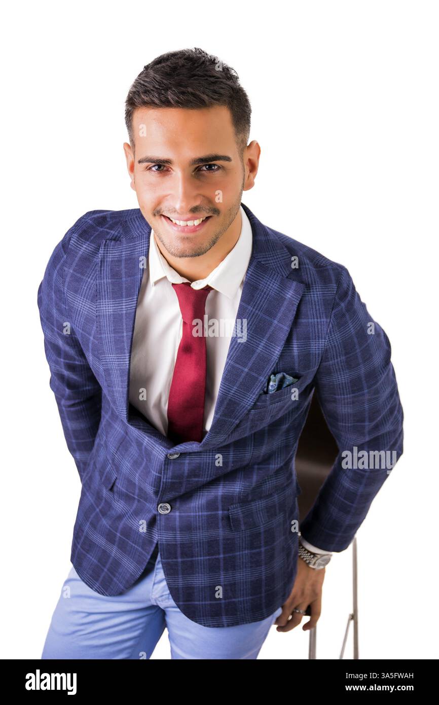 Handsome young man in blue business jacket and jeans posing isolated on ...