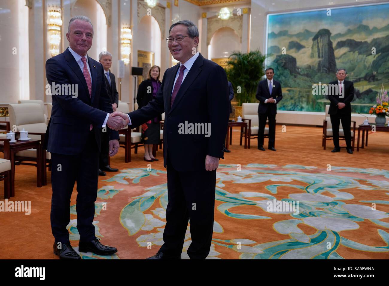 Chinese Premier Li Qiang, right, greets Boeing Global Senior VP Brendan ...