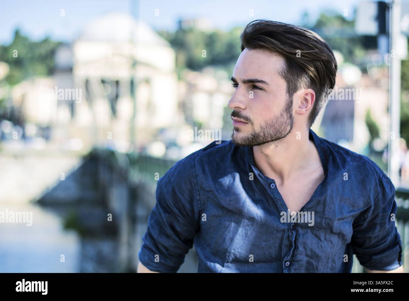 One handsome young man in urban setting in European city, Turin in ...
