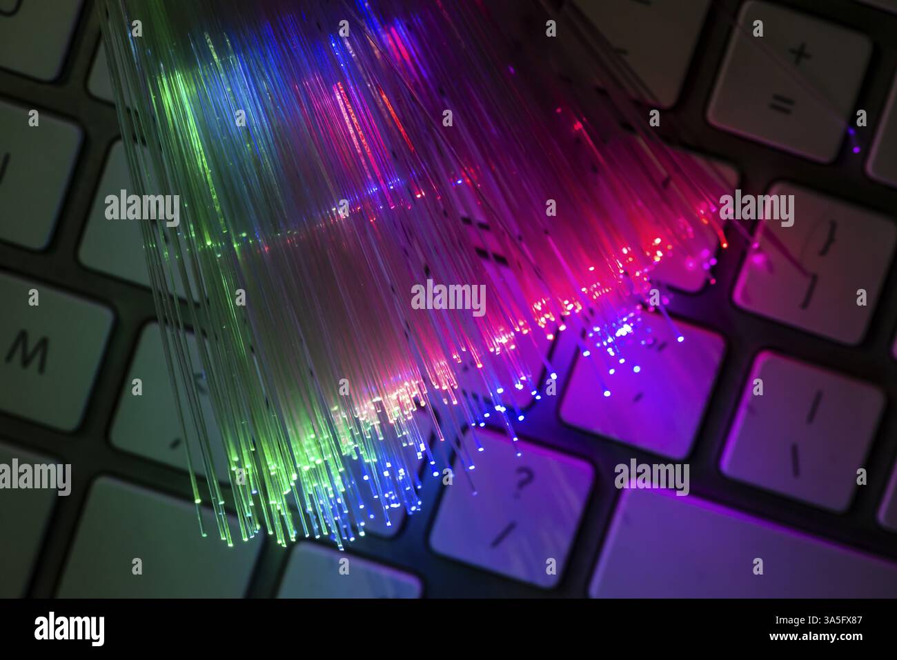 Colourful optic fibers illuminated on keyboard. High speed internet ...