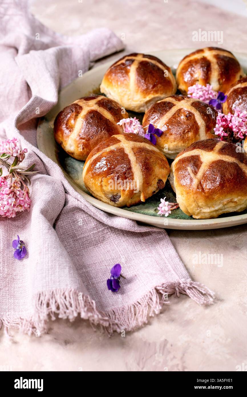 Traditional hot cross buns on ceramic plate decorated with edible ...
