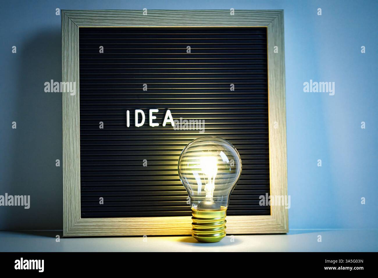 A glowing light-bulb beside a plaque bearing the word 'IDEA ...