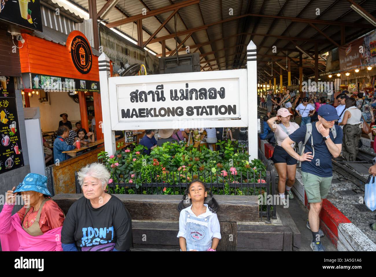 Tourists seen at the entrance to The Maeklong Railway station. Mae Klong Railway Market is one ...