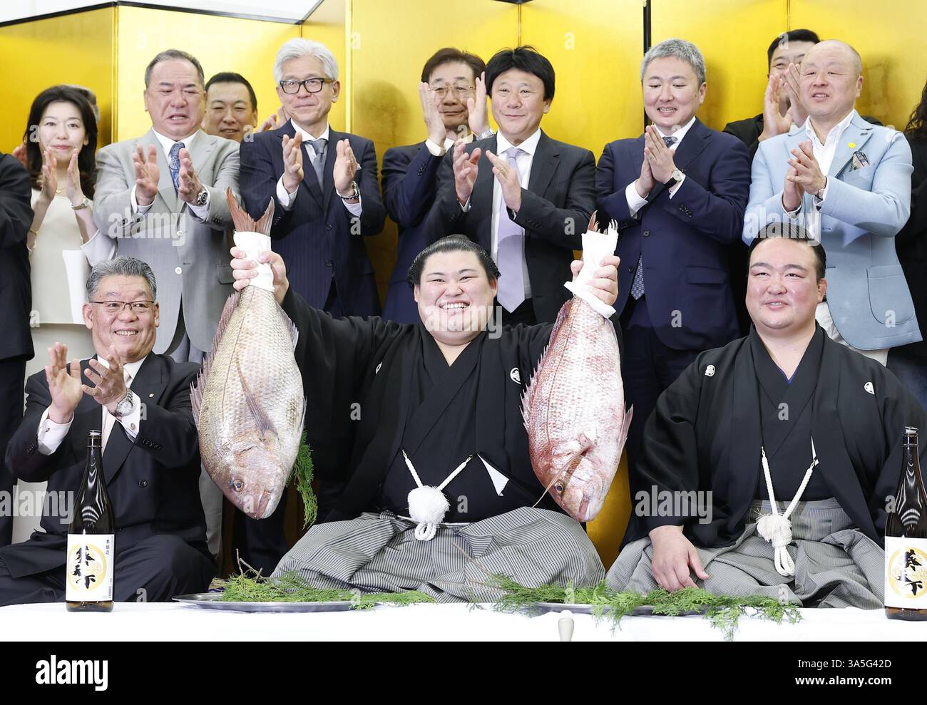 Ozeki Onosato (C) celebrates in Daito, Osaka Prefecture, on March 23 ...