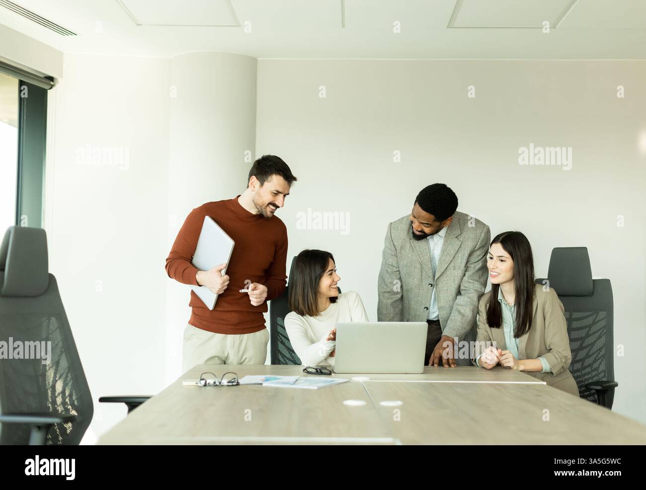 A diverse group of professionals engages in a dynamic brainstorming ...