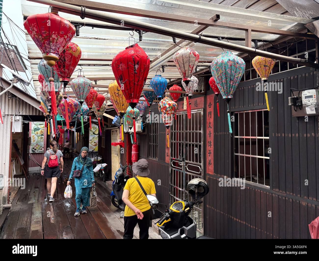 Colorful decorative lanterns hang above the walkway at Chew Jetty in ...