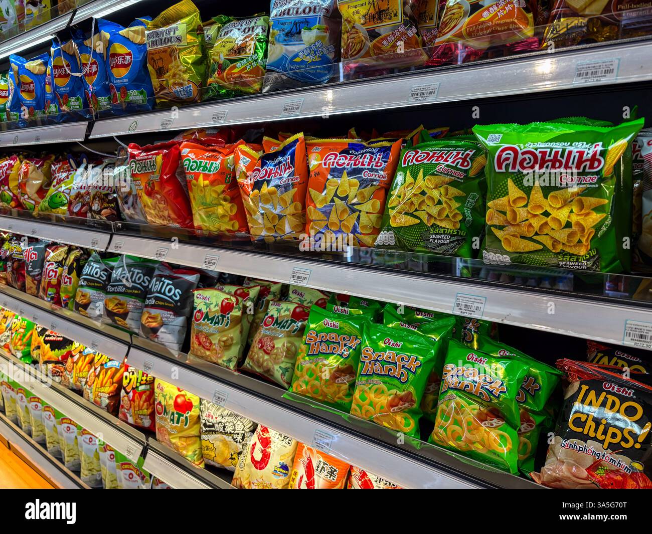 Full shelves of snack chips for sale in a grocery store in Southeast ...