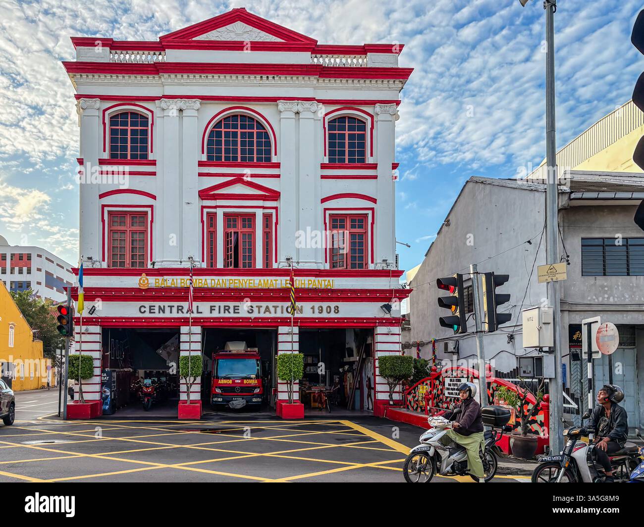 Traffic passing the Central Fire Station, built in 1908, in George Town ...