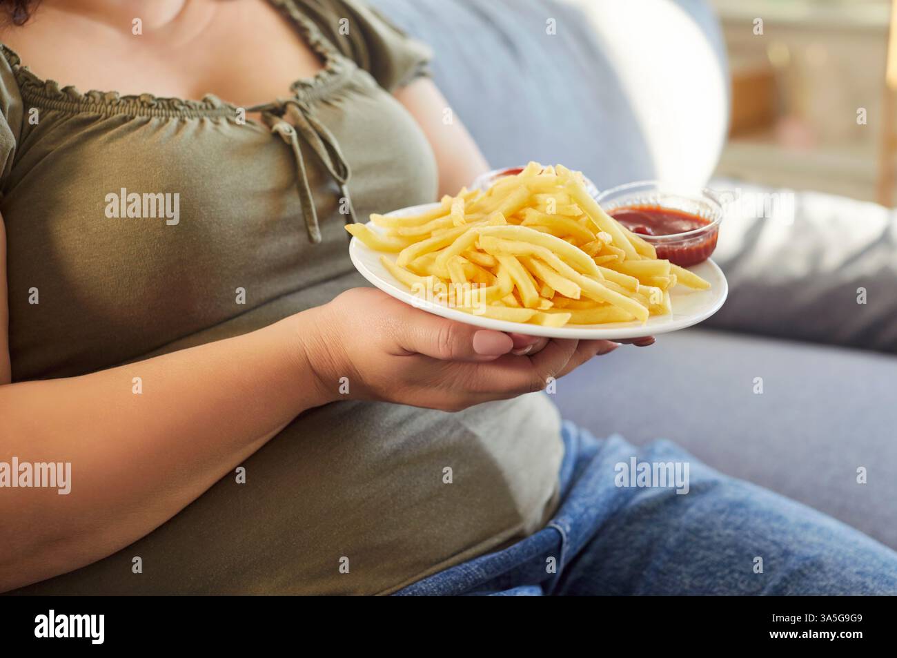 Overweight woman enjoying tasty food hi-res stock photography and ...
