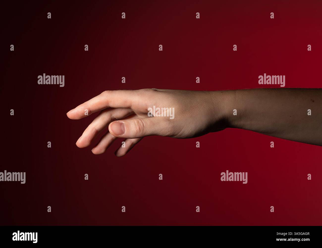 Hand reaching out, fingers gently stretching, pointing, showing subtle ...