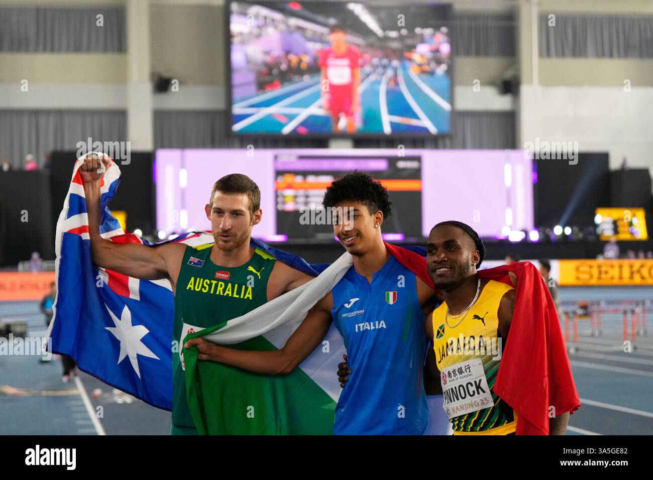 Bronze medalist Liam Adcock, of Australia, gold medalist Mattia Furlani ...