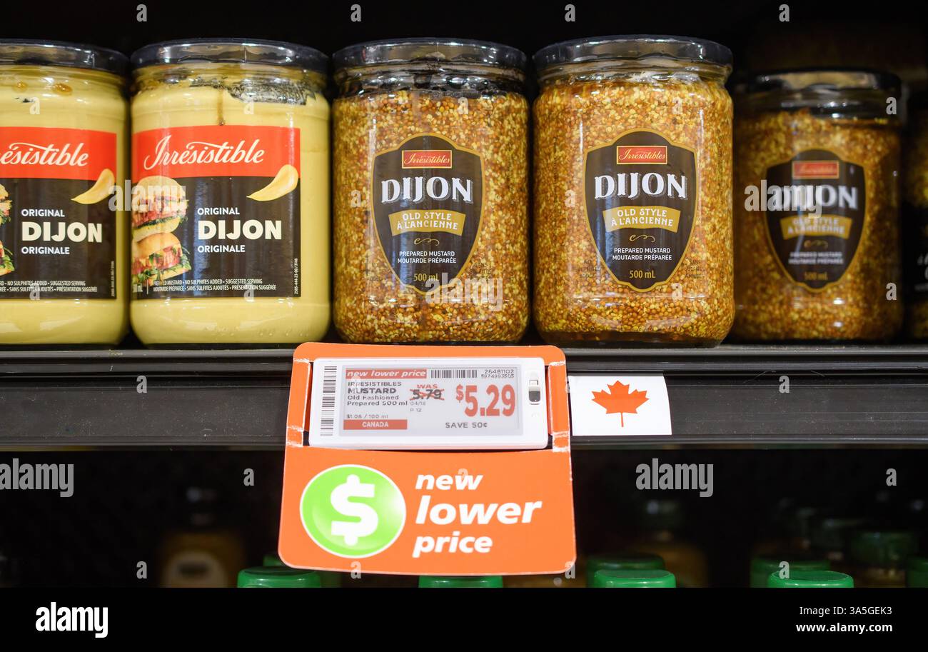 Glass containers of Dijon mustard on a store shelf, marked with the ...