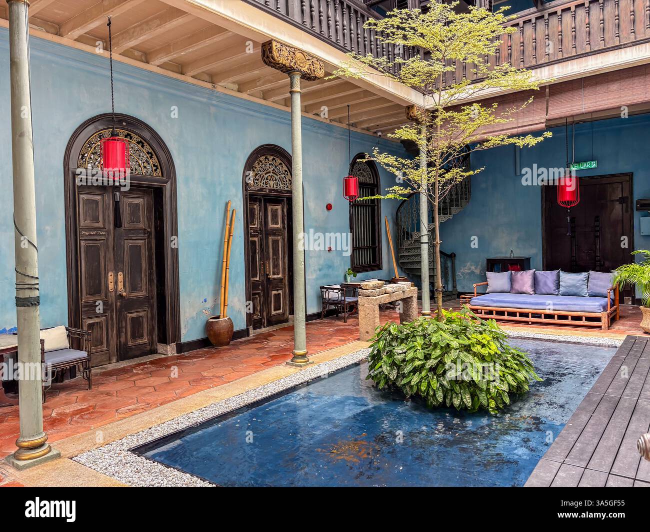 Central courtyard with pond, furniture and potted plants at Cheong Fatt ...