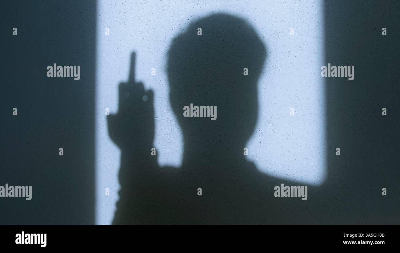 Person Making Middle Finger Gesture in Shadow Silhouette – Symbol of ...