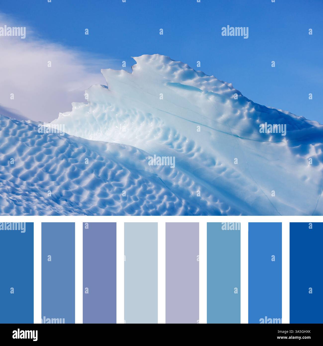 Jagged edge detail of a blue iceberg against blue sky and cloud ...