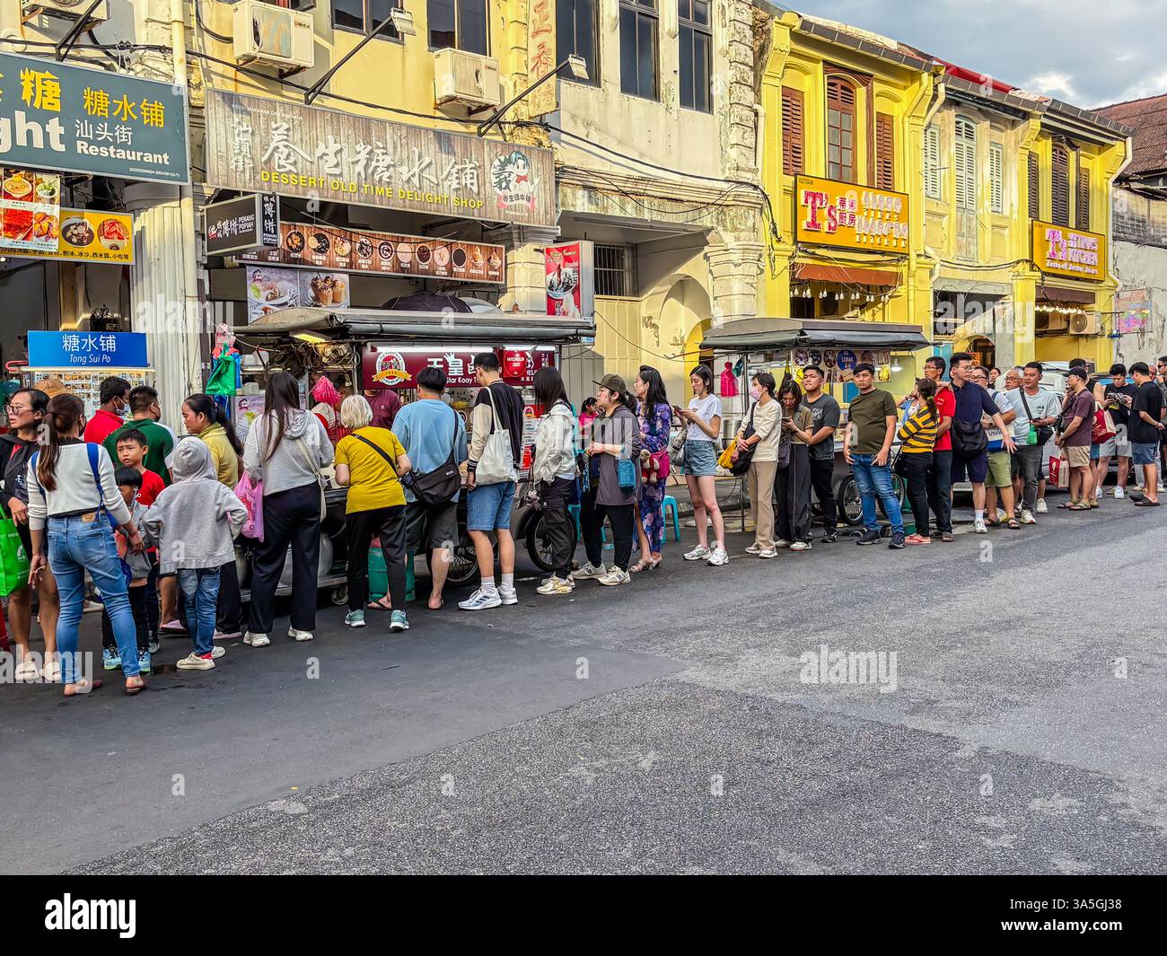 A long line of people queueing up at a street food vendor in George ...