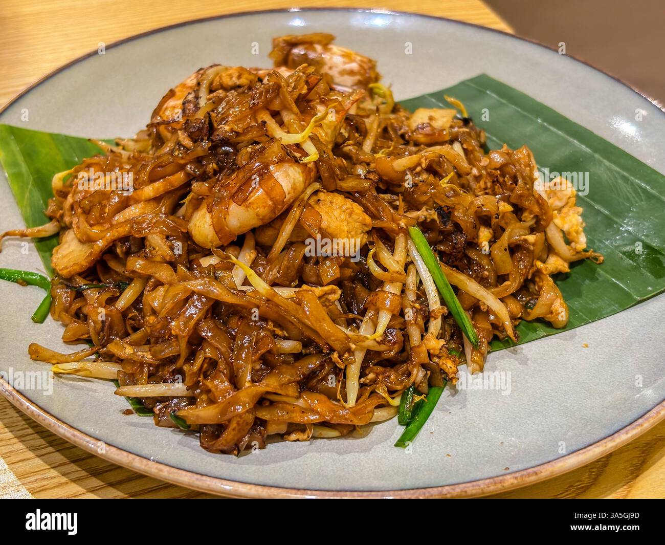 Char kway teow is a popular fried noodle dish in Malaysia. Prepared ...