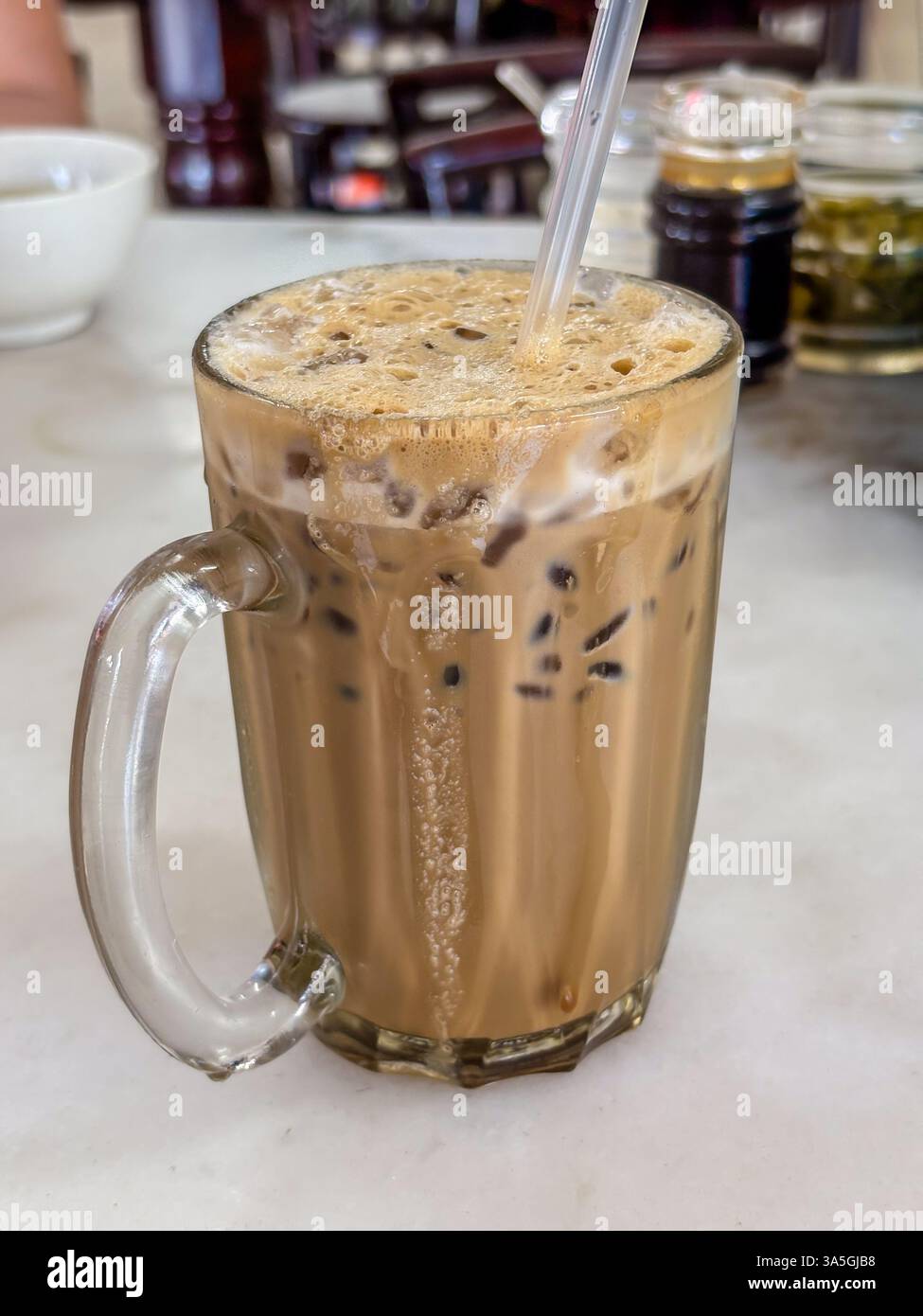 Classic ice coffee beverage at a kopitiam in Malaysia. Showing the ice ...