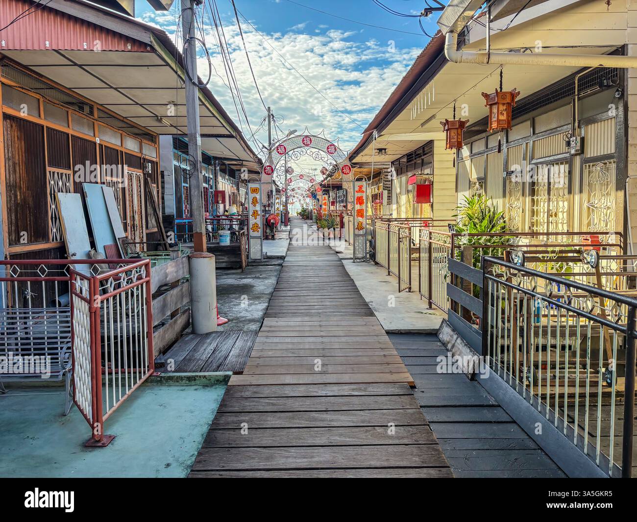 Walking path with wooden boardwalk passing stilt houses at Lee Jetty in ...