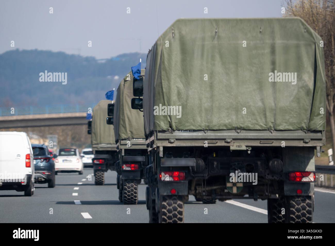 A9, Germany - 23 March 2025: Several camouflaged military trucks with ...