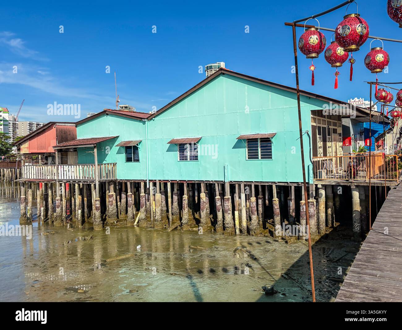 Blue and red houses at Lee Clan Jetty in Georgetown, Penang, Malaysia. View during low tide with ...