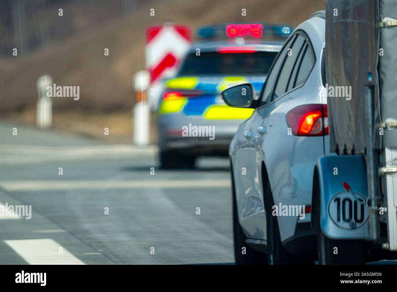 A9, Germany - March 23, 2025: A police vehicle on the highway displays ...