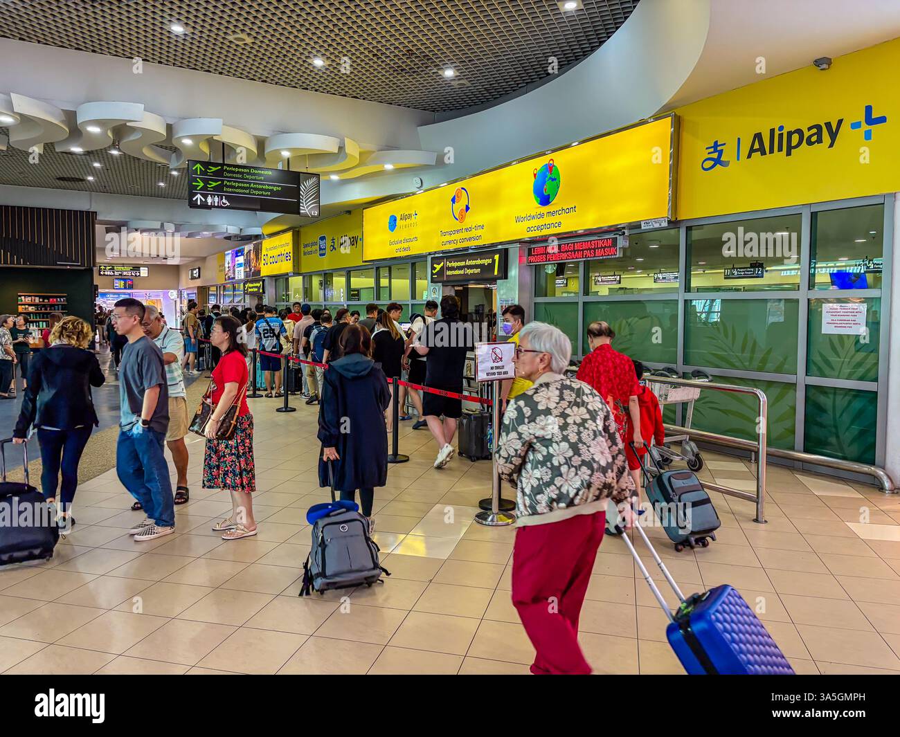 Passengers in Penang airport depature security line Stock Photo - Alamy