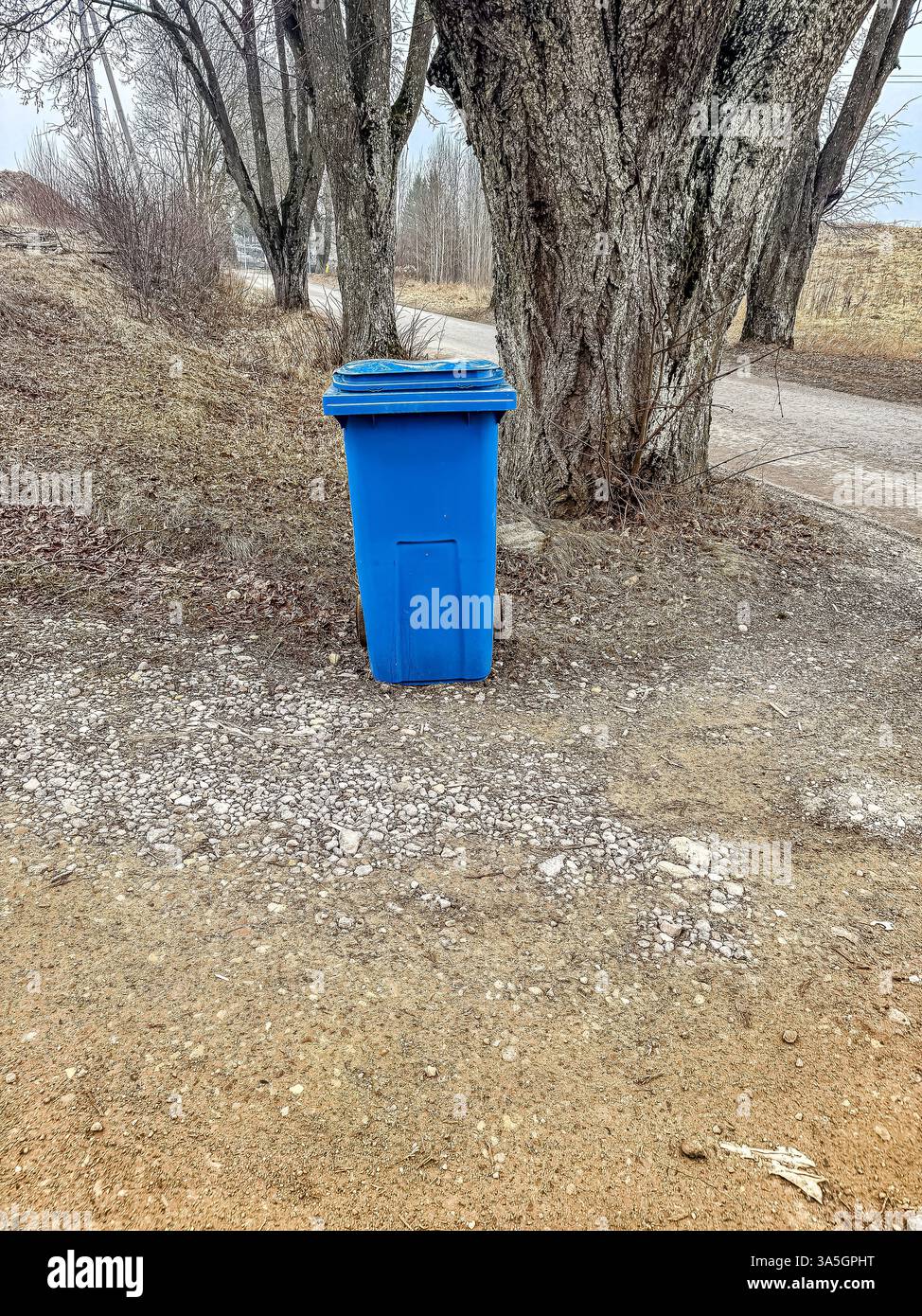 Blue Garbage Bin on Rural Gravel Path, Trees in Background, Outdoor ...