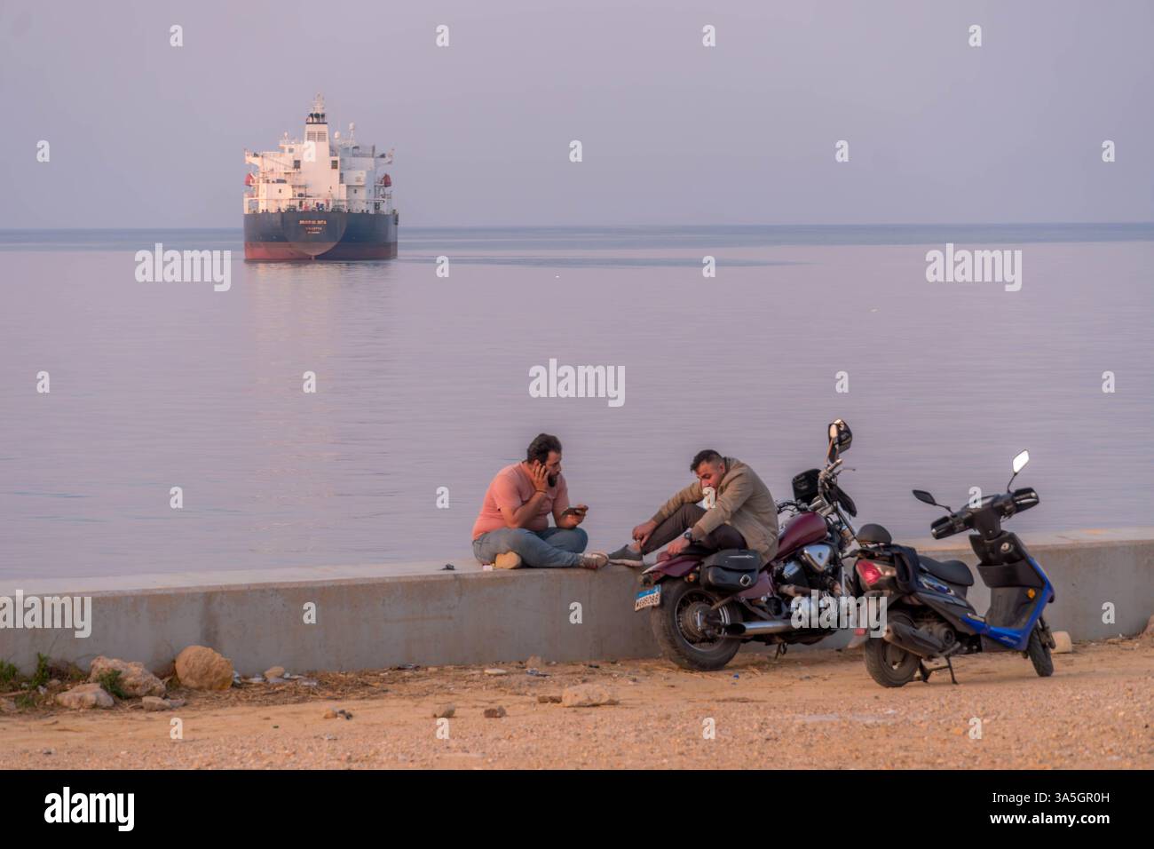 Two local Lebanese men on the Beirut waterfront, with the motorcycle ...