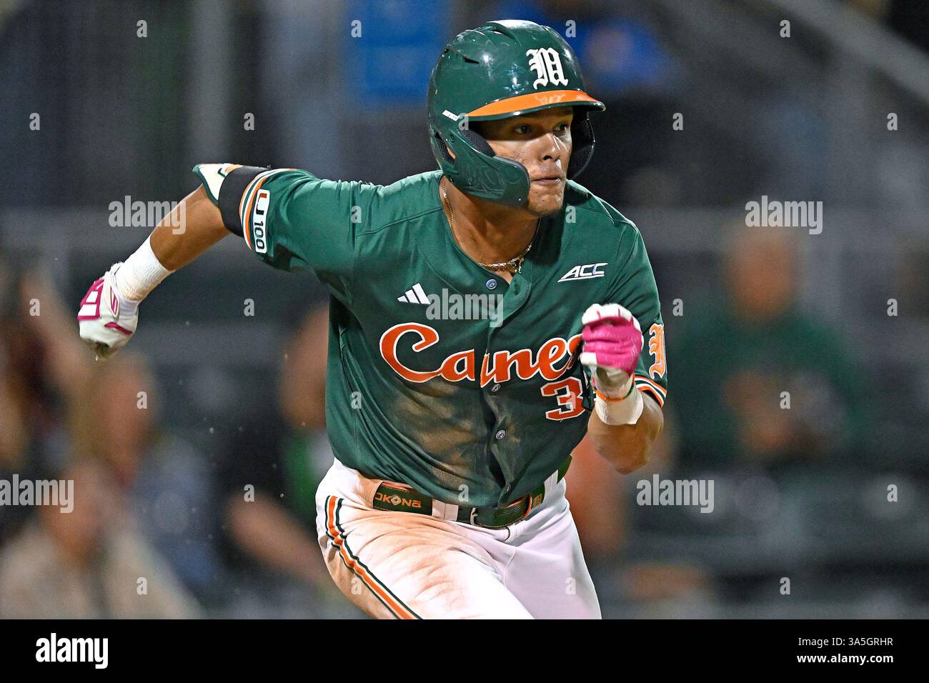 CORAL GABLES, FL - MARCH 22: Miami outfielder Fabio Peralta (37) runs ...