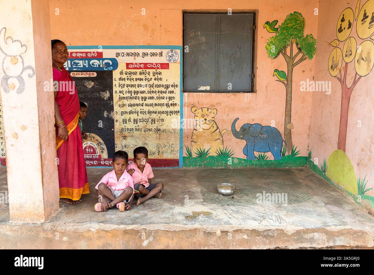 Kids and a teacher at the local primary school in Orissa India, walls ...