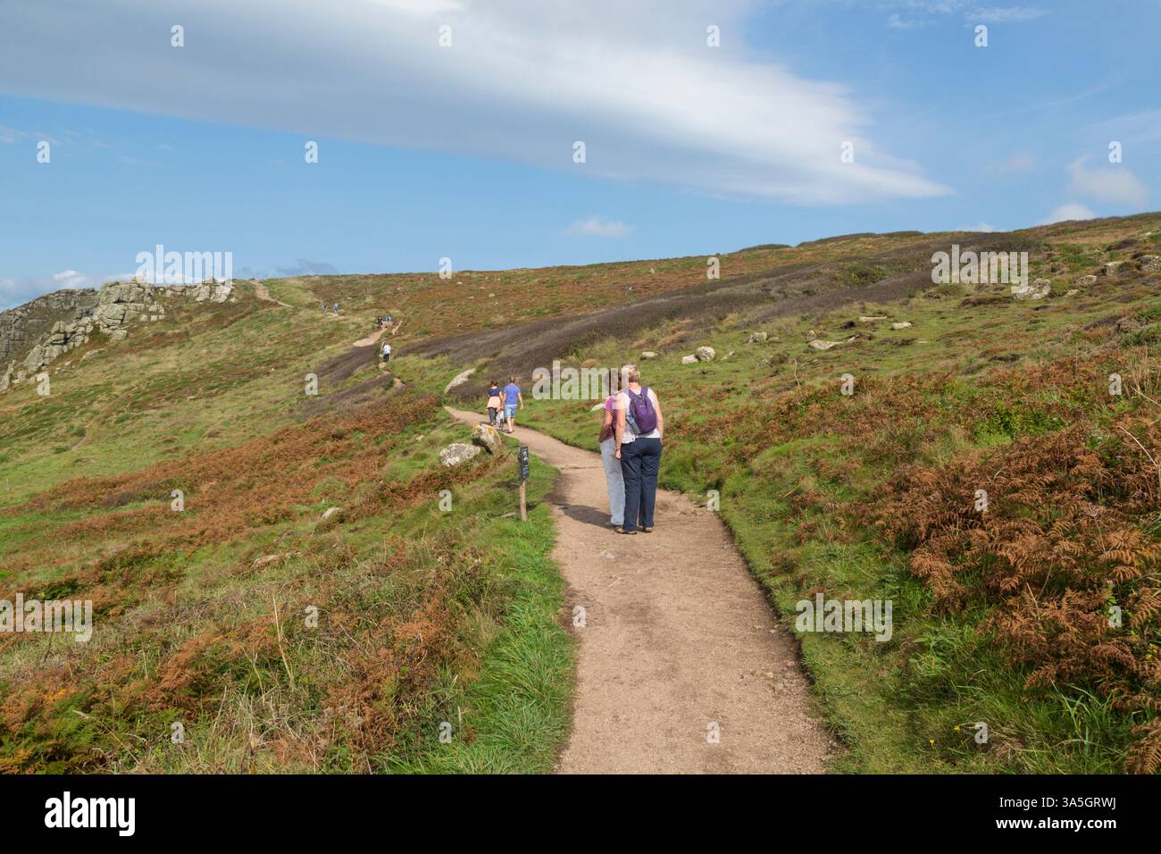 Walkers on coastal path Stock Photo - Alamy