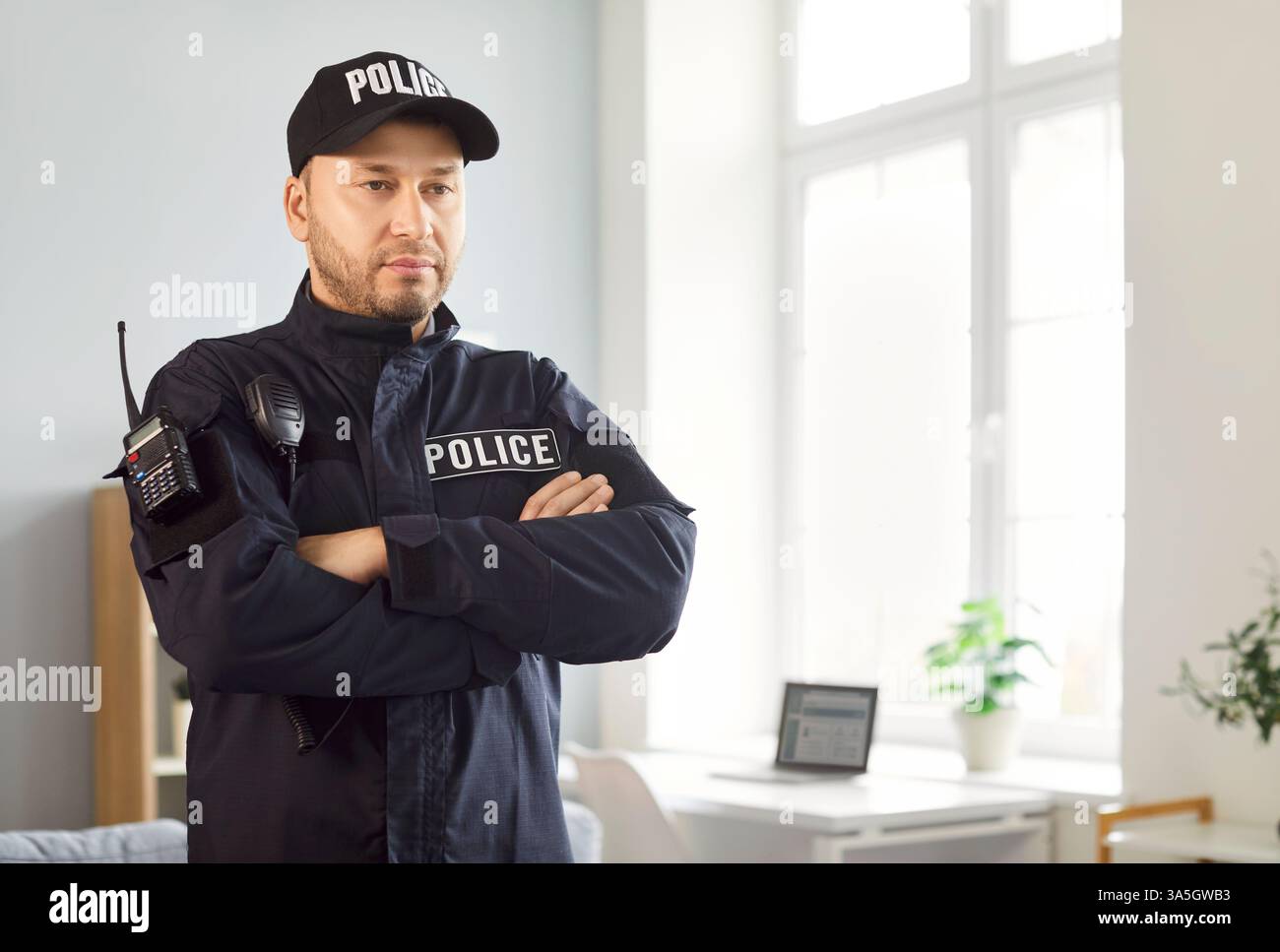 Portrait of confident male police officer standing in office wearing ...