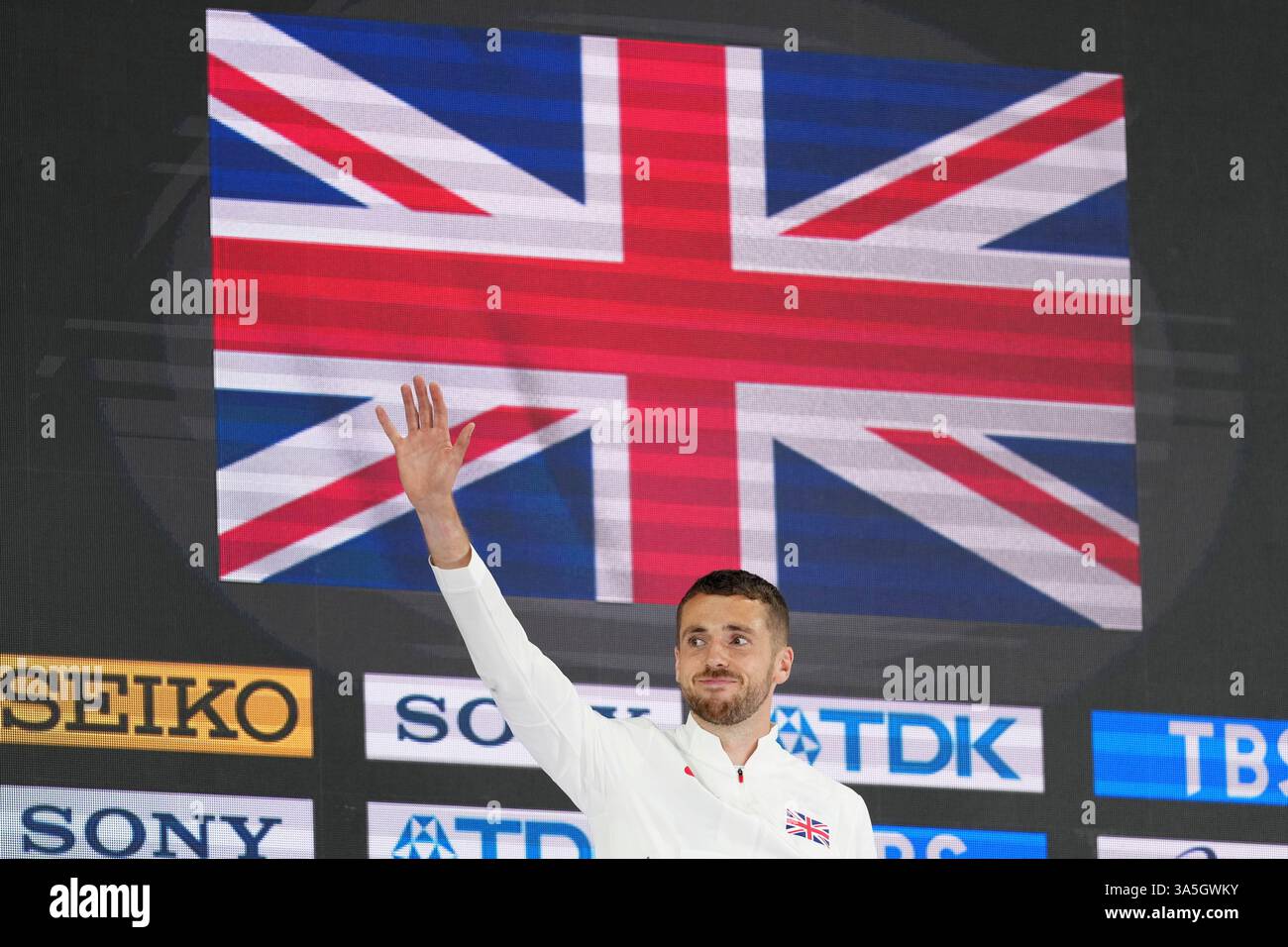 Neil Gourley, of Great Britain, waves on the podium after winning the ...