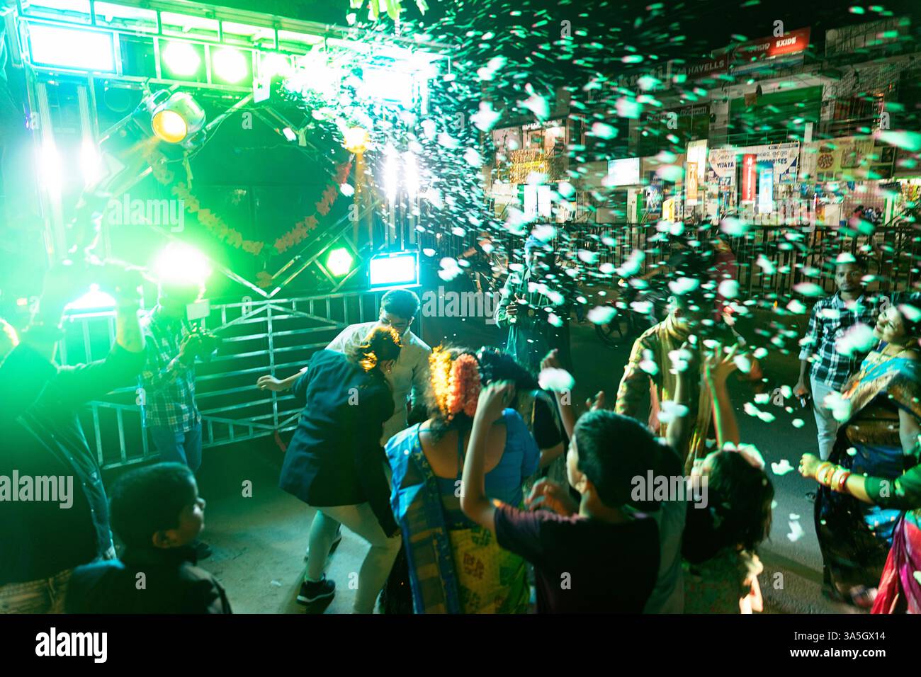 People celebrating on a street, dancing behind a truck with radio ...