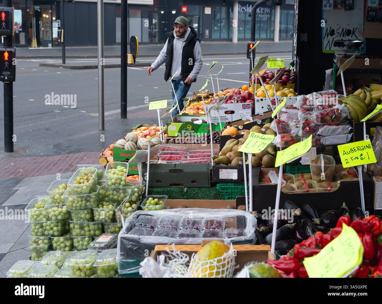 Slough, Berkshire, UK. 23rd March, 2025. A man walks past a shop ...