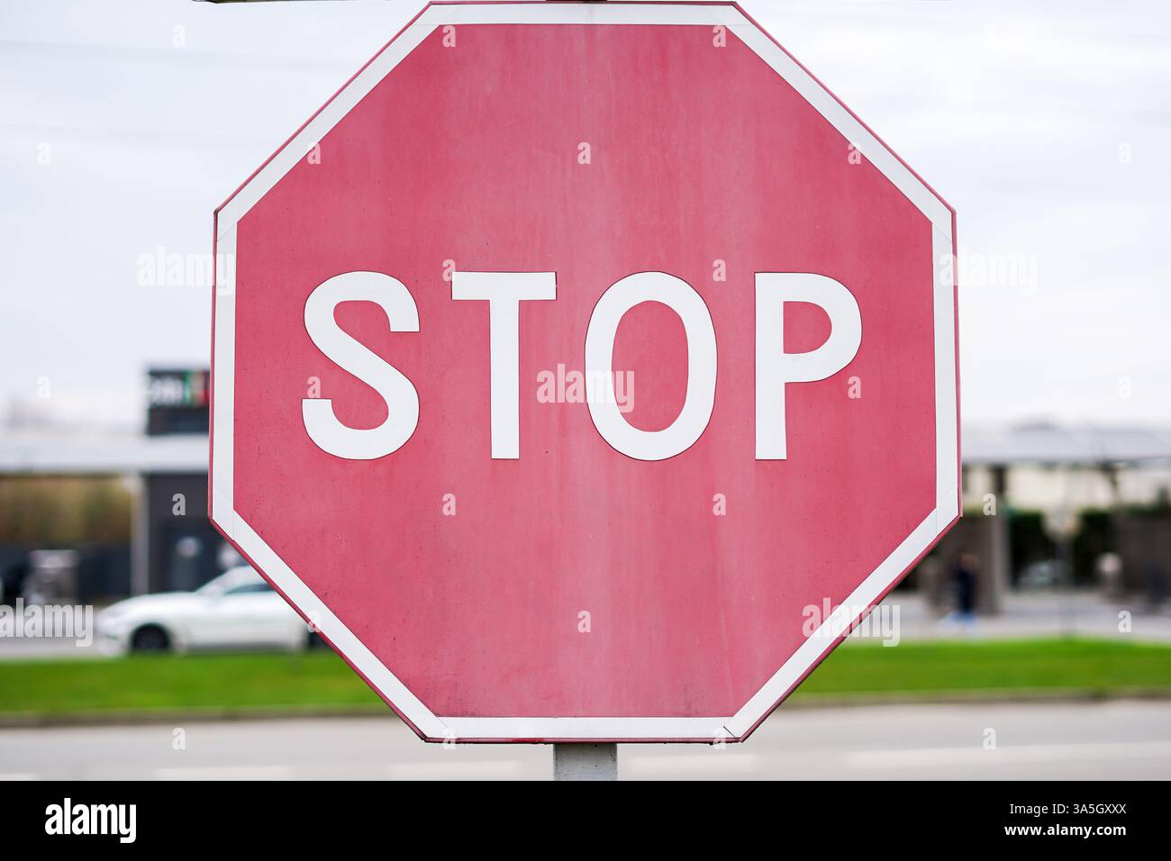 a red stop sign with white lettering, prominently displayed beside a ...