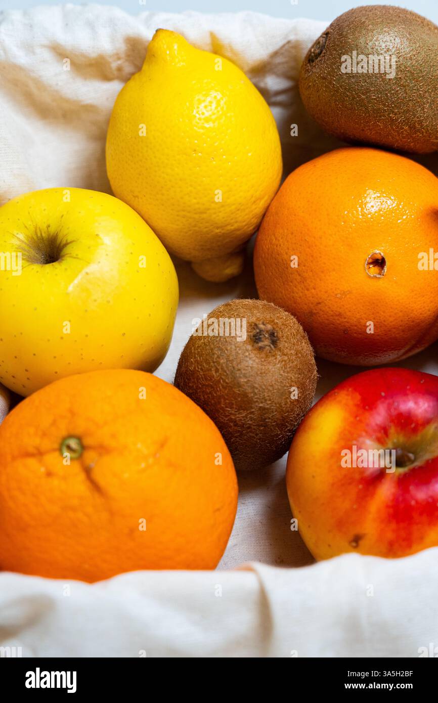 A colorful mix of fruits, including apples, sour lemons, juicy kiwis ...