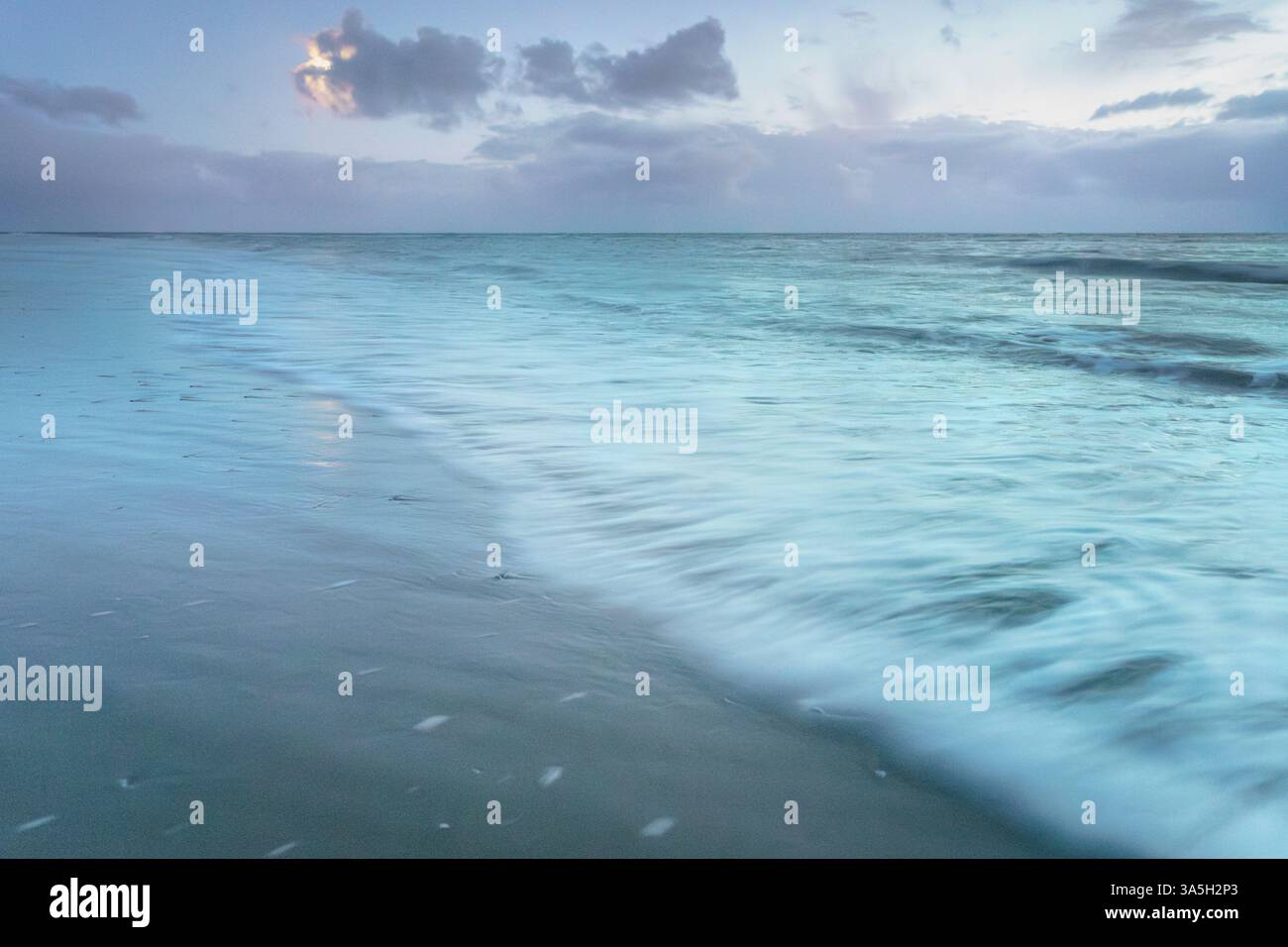 North sea coast with rolling waves on the beach during nightfall Stock ...