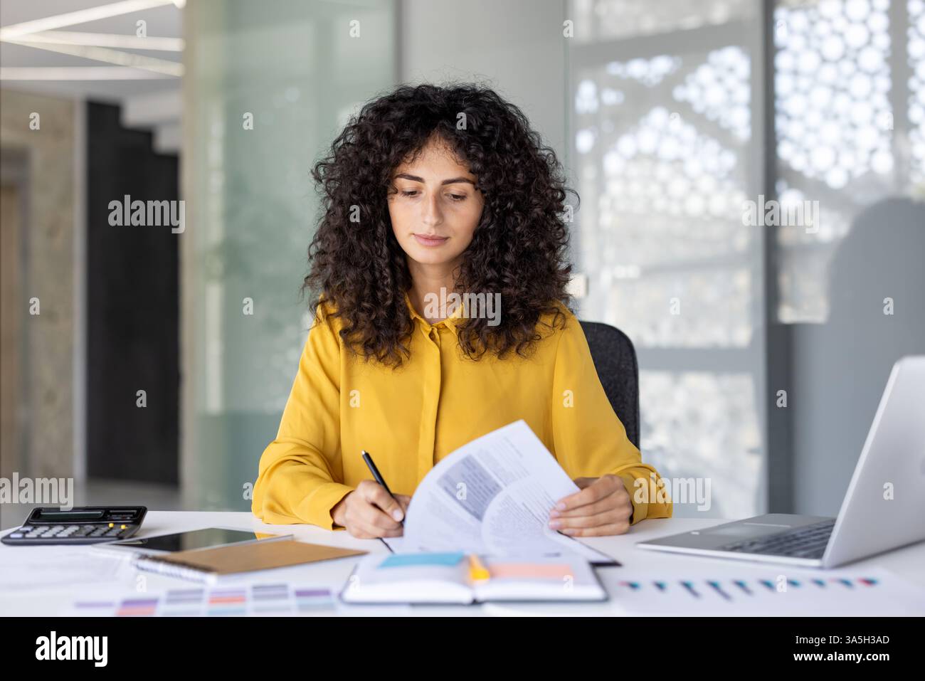 Tax review woman examining hi-res stock photography and images - Alamy