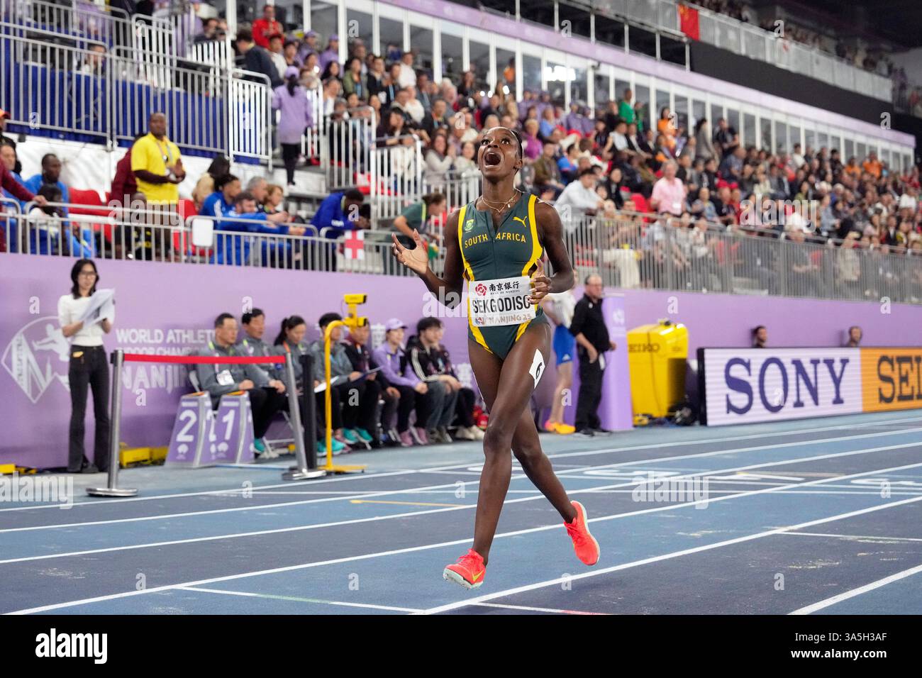 Prudence Sekgodiso, of South Africa, reacts after crossing the finish ...