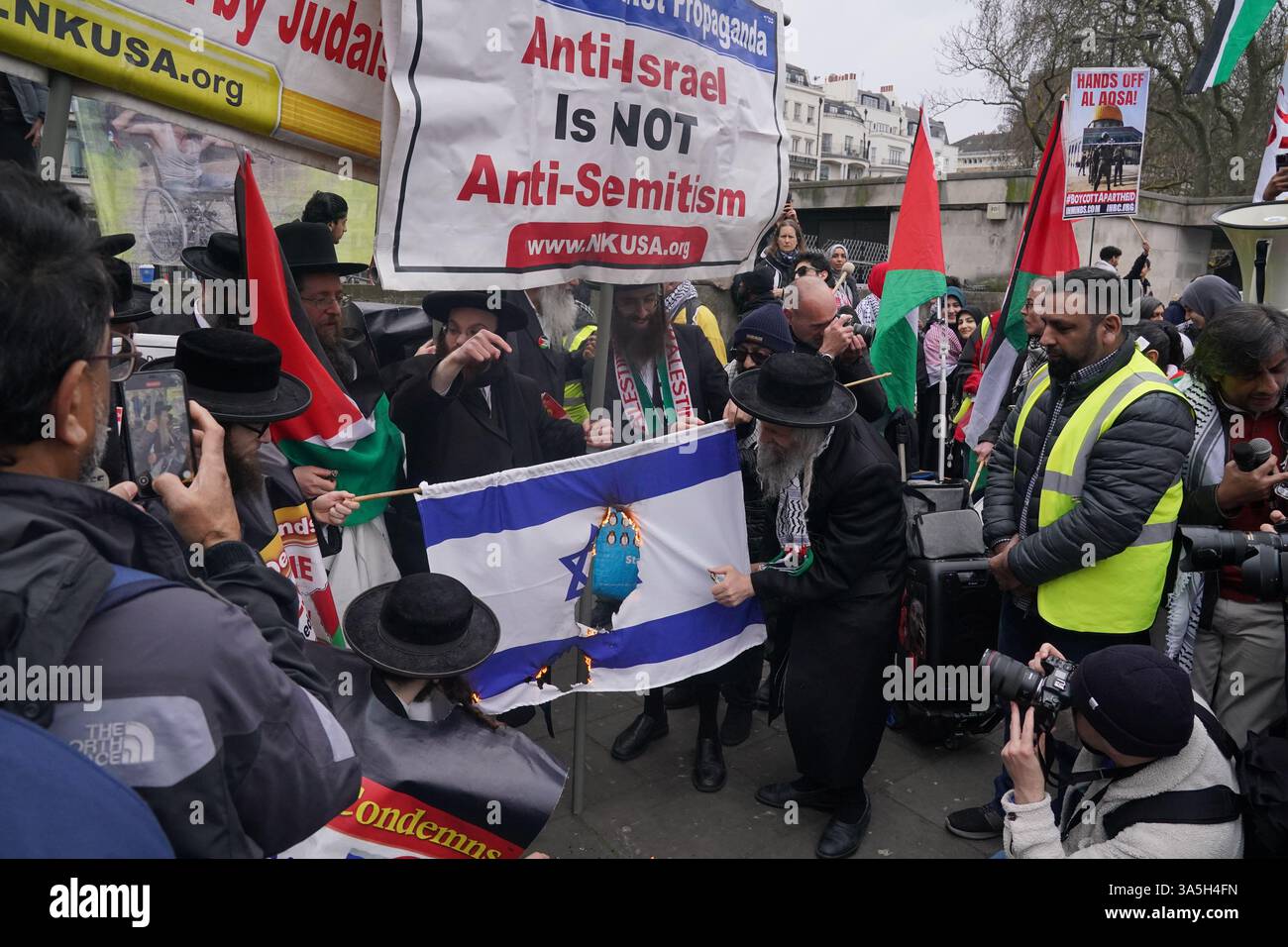 Rabbis from Neturei Karta International burn a Israeli flag during a ...