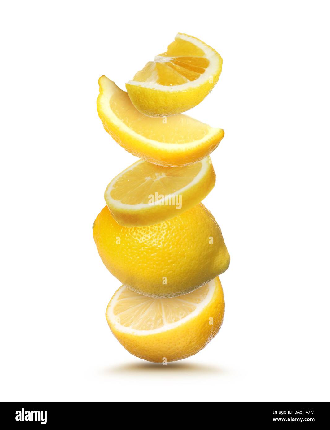Cut and whole fresh lemons falling on white background Stock Photo - Alamy