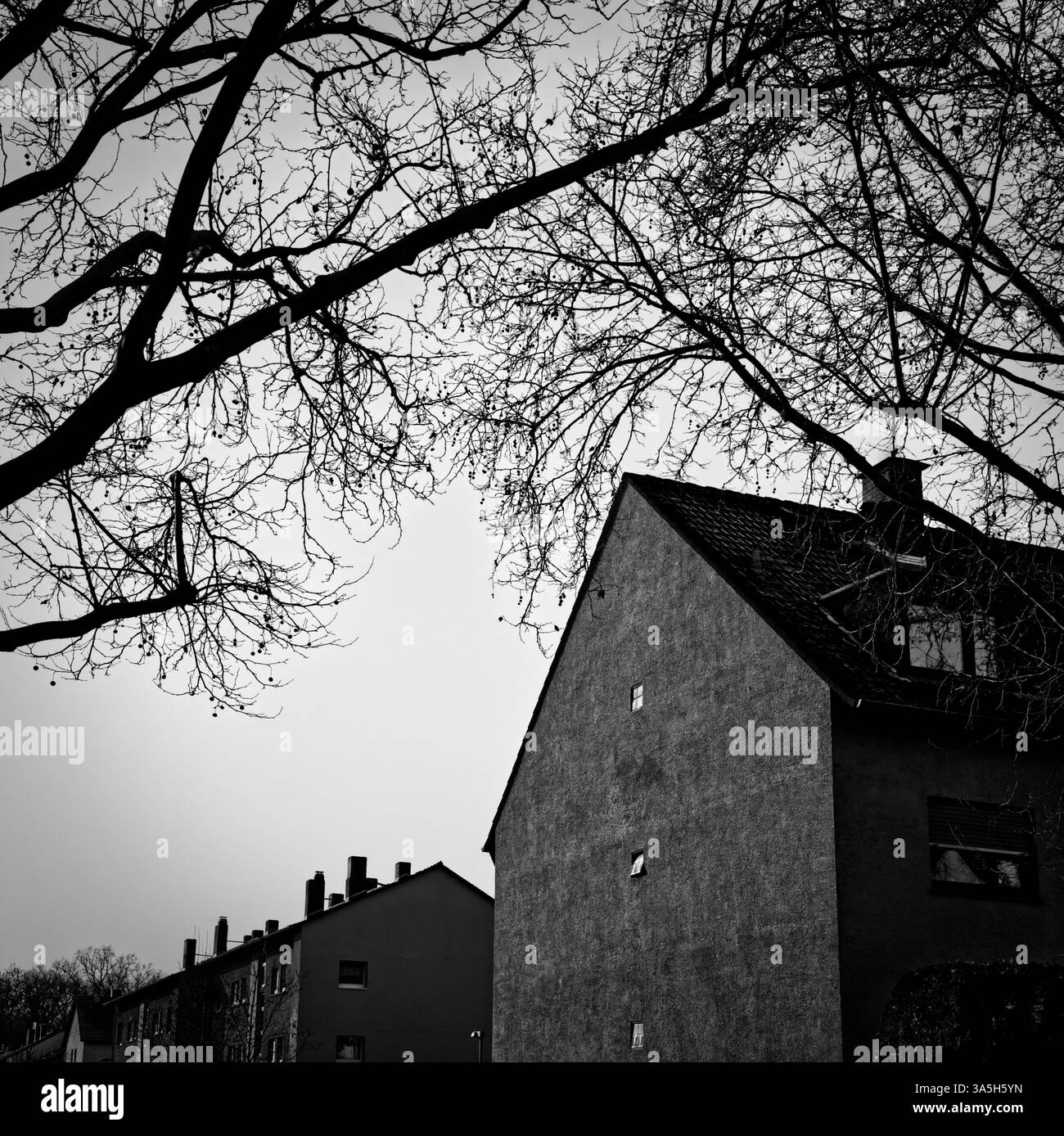 building with a roughcast at its house front and three small windows, black and white photograph ...