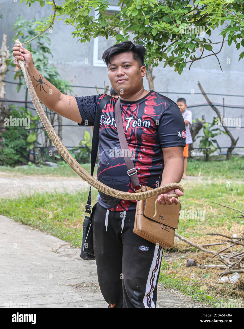 Laguna, Philippines. March 23, 2025. Capture & rescue of a Philippine ...